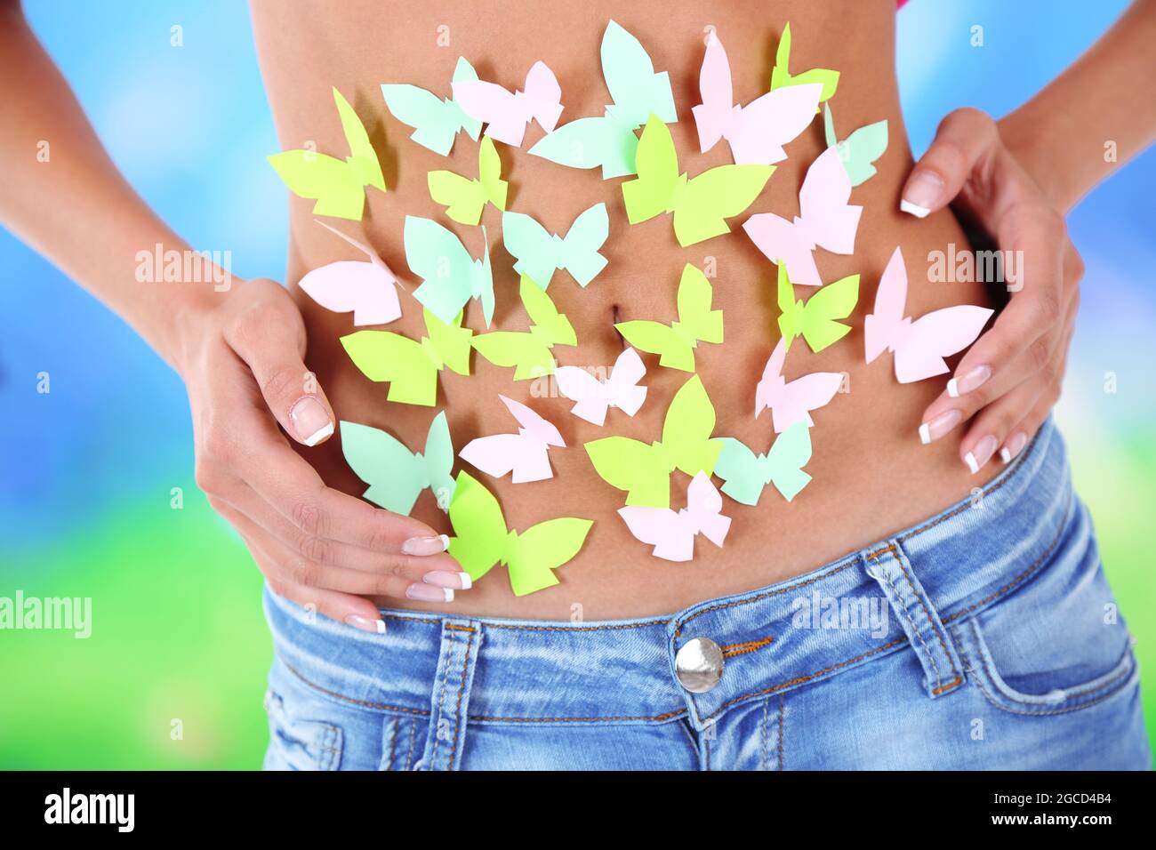 Butterfly on stomach on light background Stock Photo - Alamy