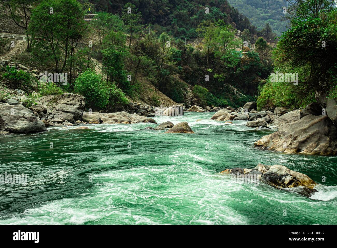 mountain river extreme water flow at forests in day long exposure shot ...