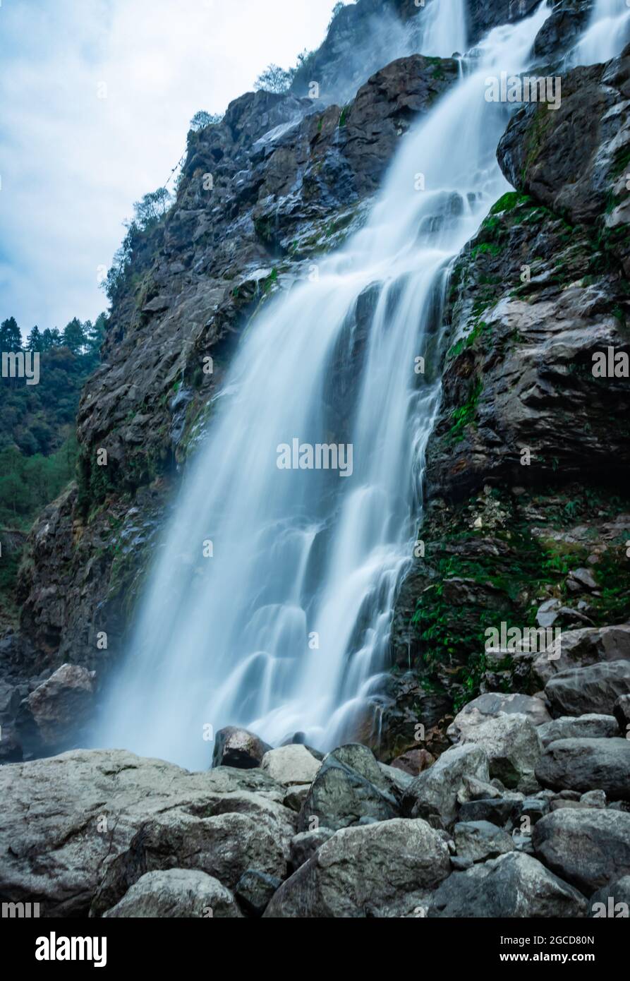 waterfall white water stream falling from mountains at day from flat ...