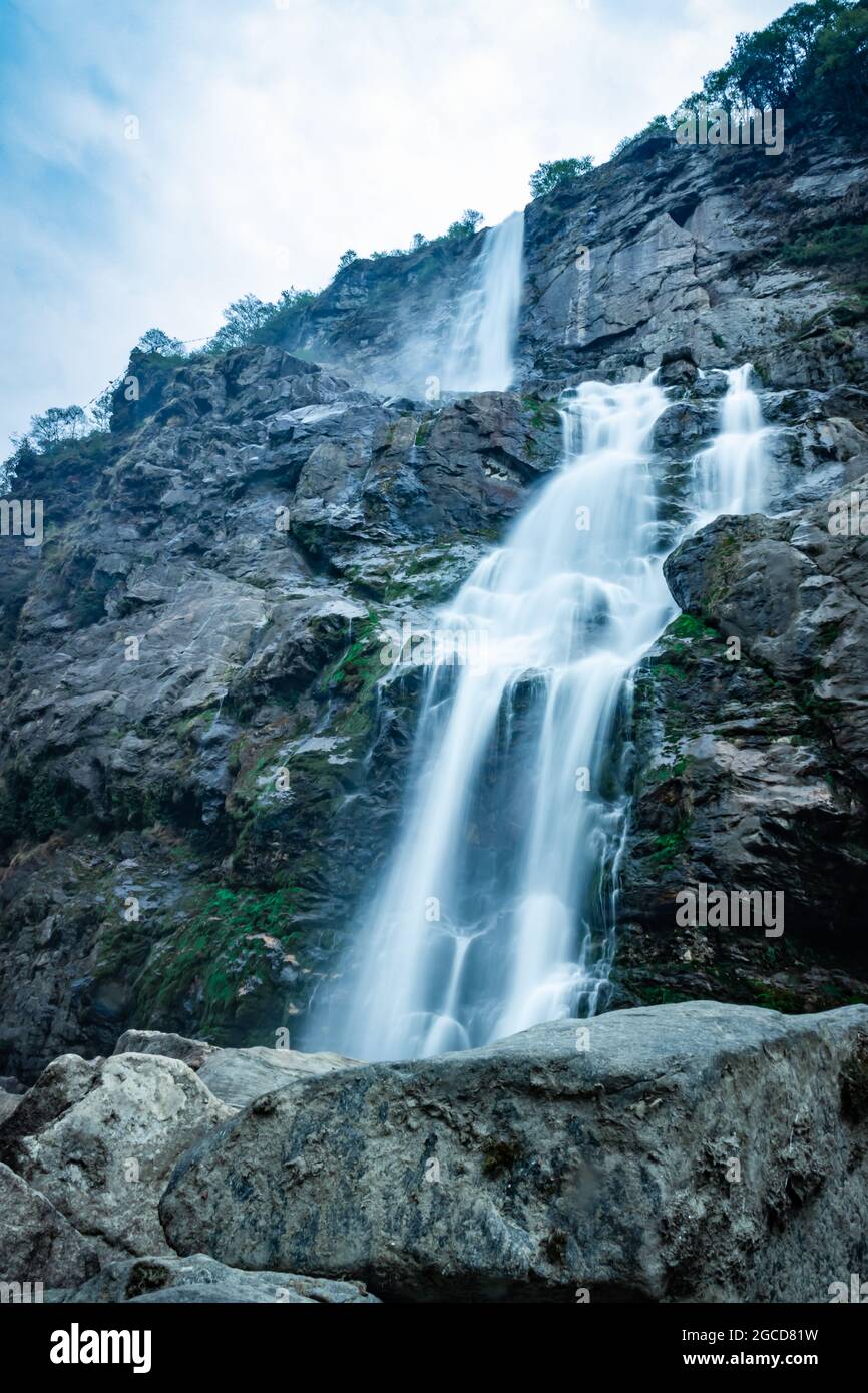 waterfall white water stream falling from mountains at day from flat ...