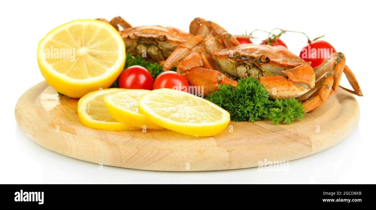 Boiled crabs with lemon slices and tomatoes, on wooden board, isolated on white Stock Photo - Alamy