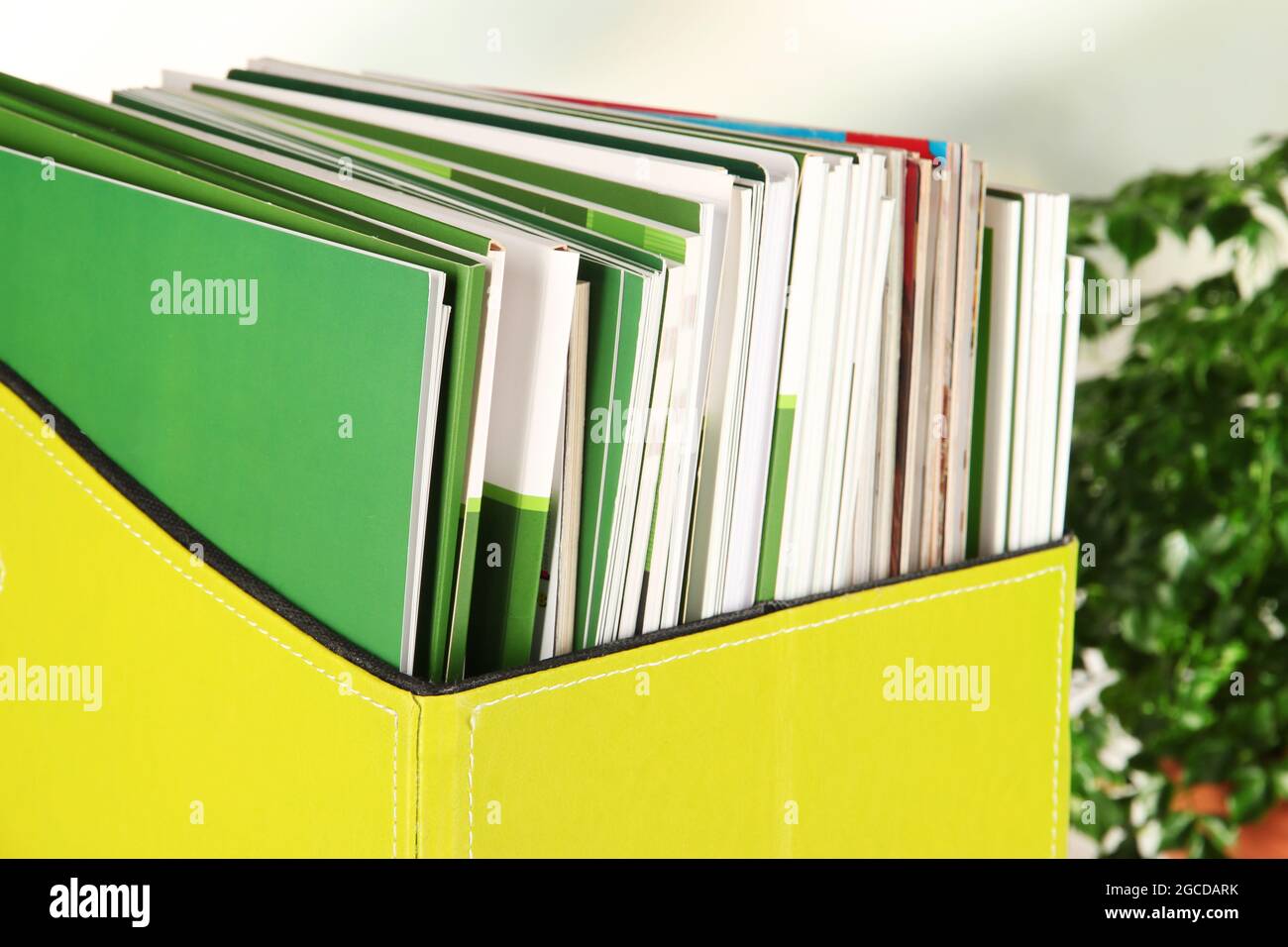 Magazines and folders in green box,on office interior background Stock ...