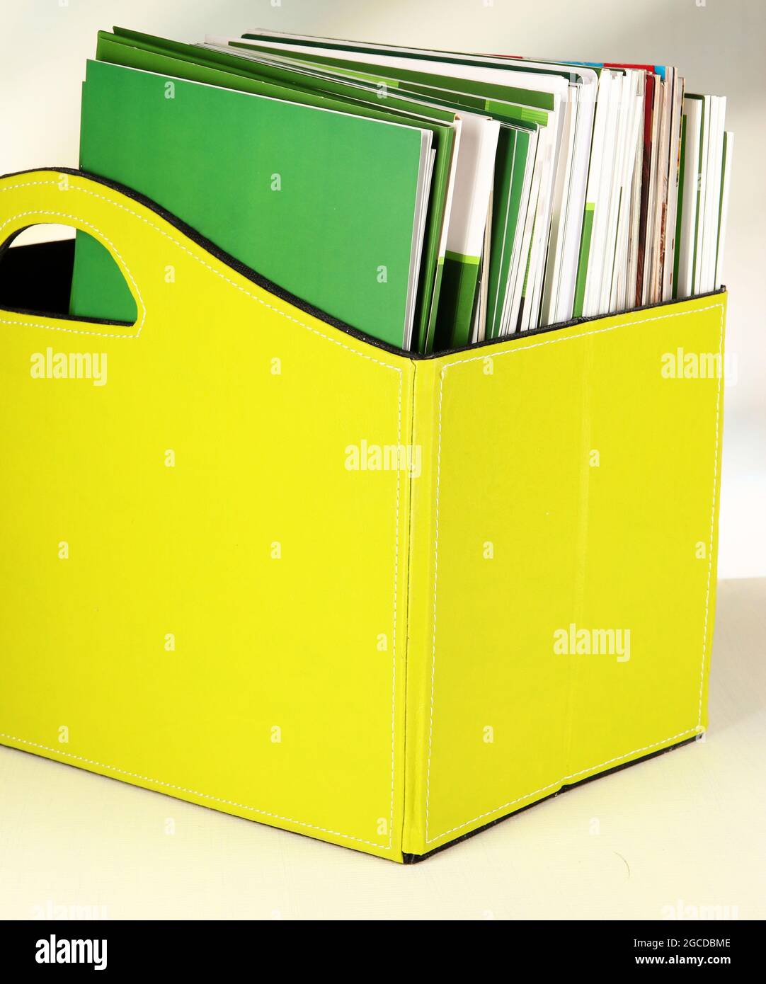 Magazines and folders in green box, isolated on white Stock Photo - Alamy
