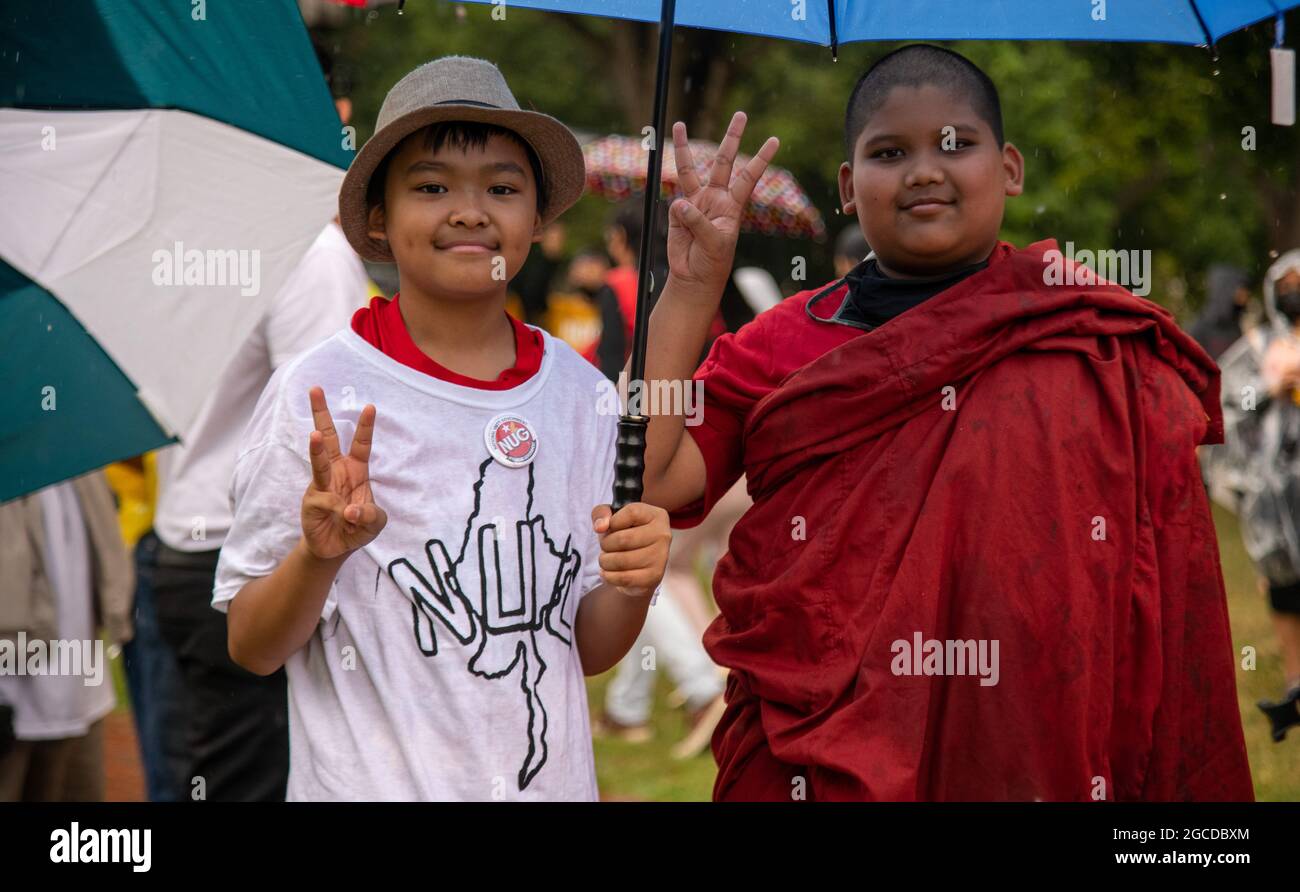 Two children make a three-finger salute, a gesture used as an anti-coup ...