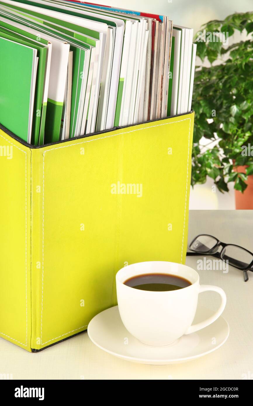 Magazines and folders in green box,on office interior background Stock ...