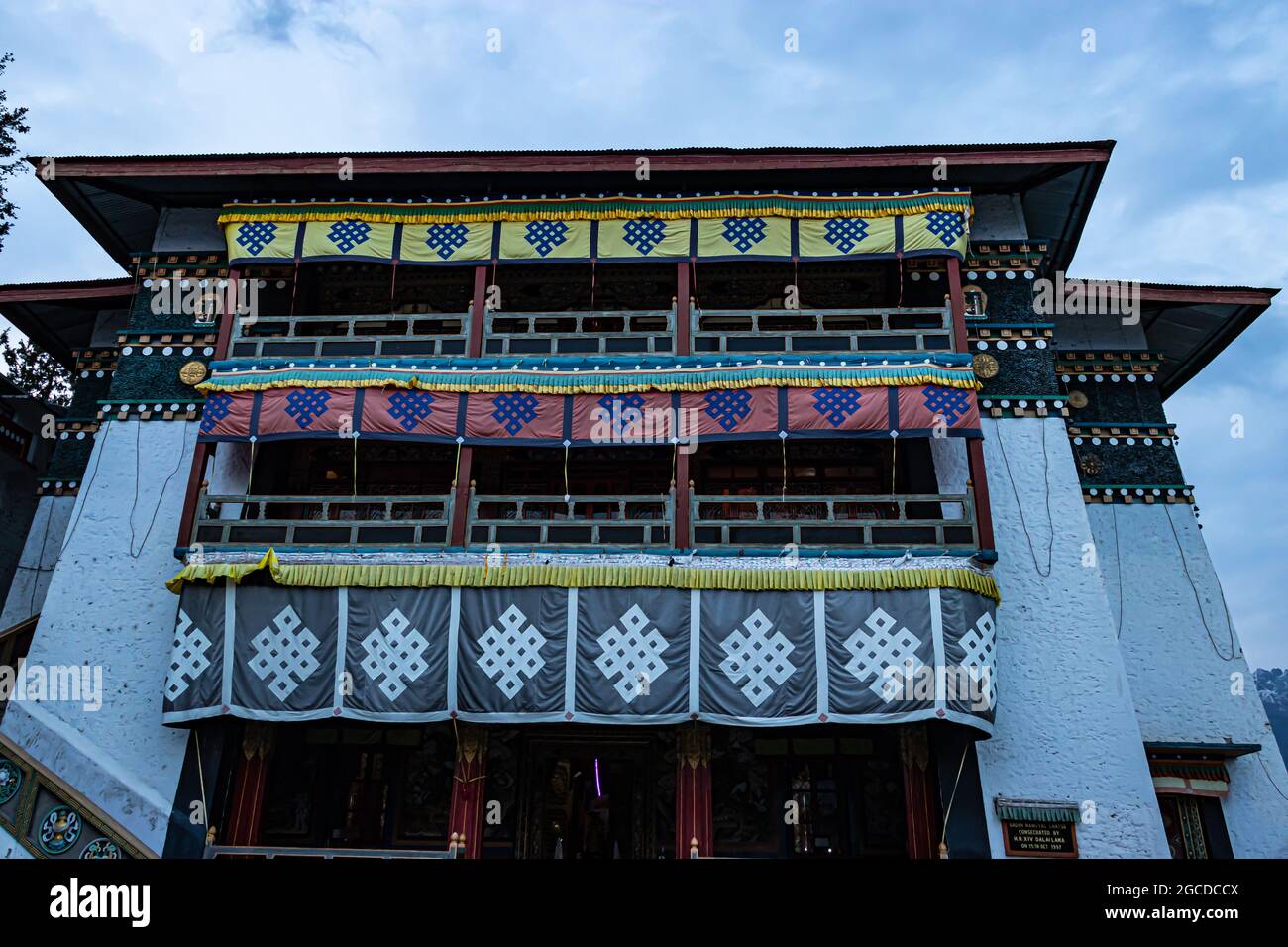 Buddhist monastery with decorated religious flags at day from low angle ...