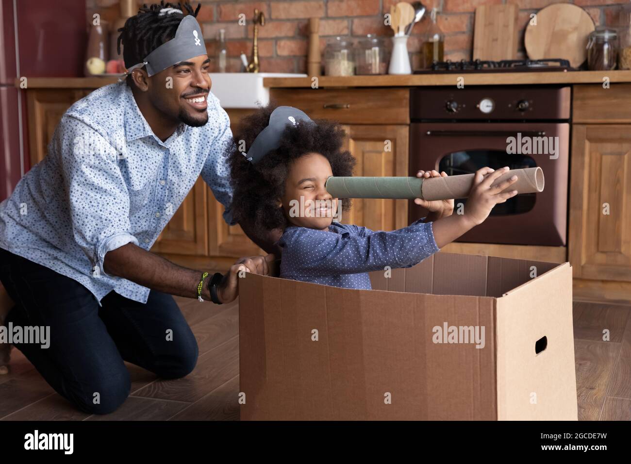 Happy ethnic dad and daughter play pirates together Stock Photo - Alamy