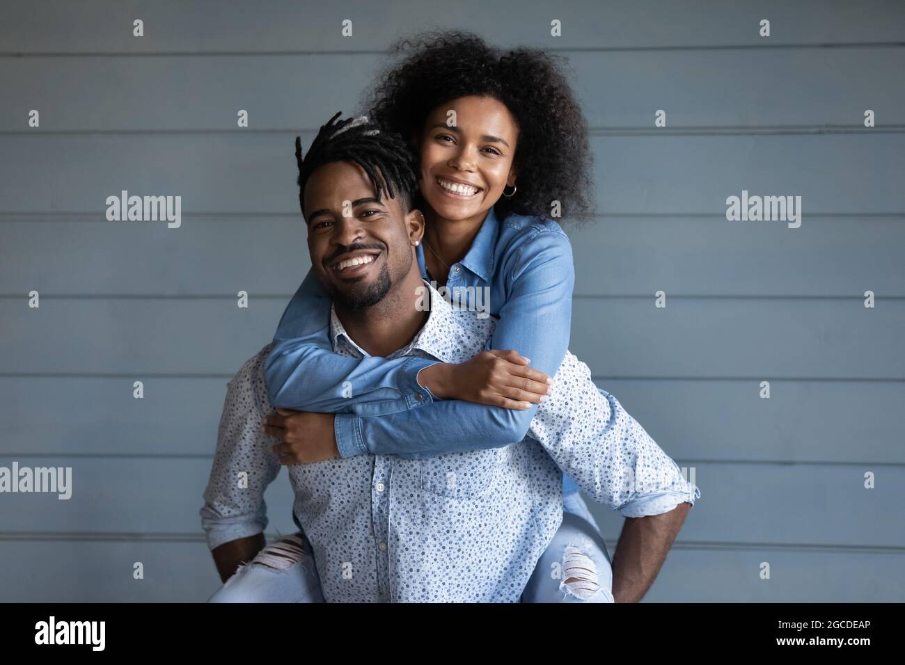Portrait of happy ethnic couple hugging embracing Stock Photo - Alamy