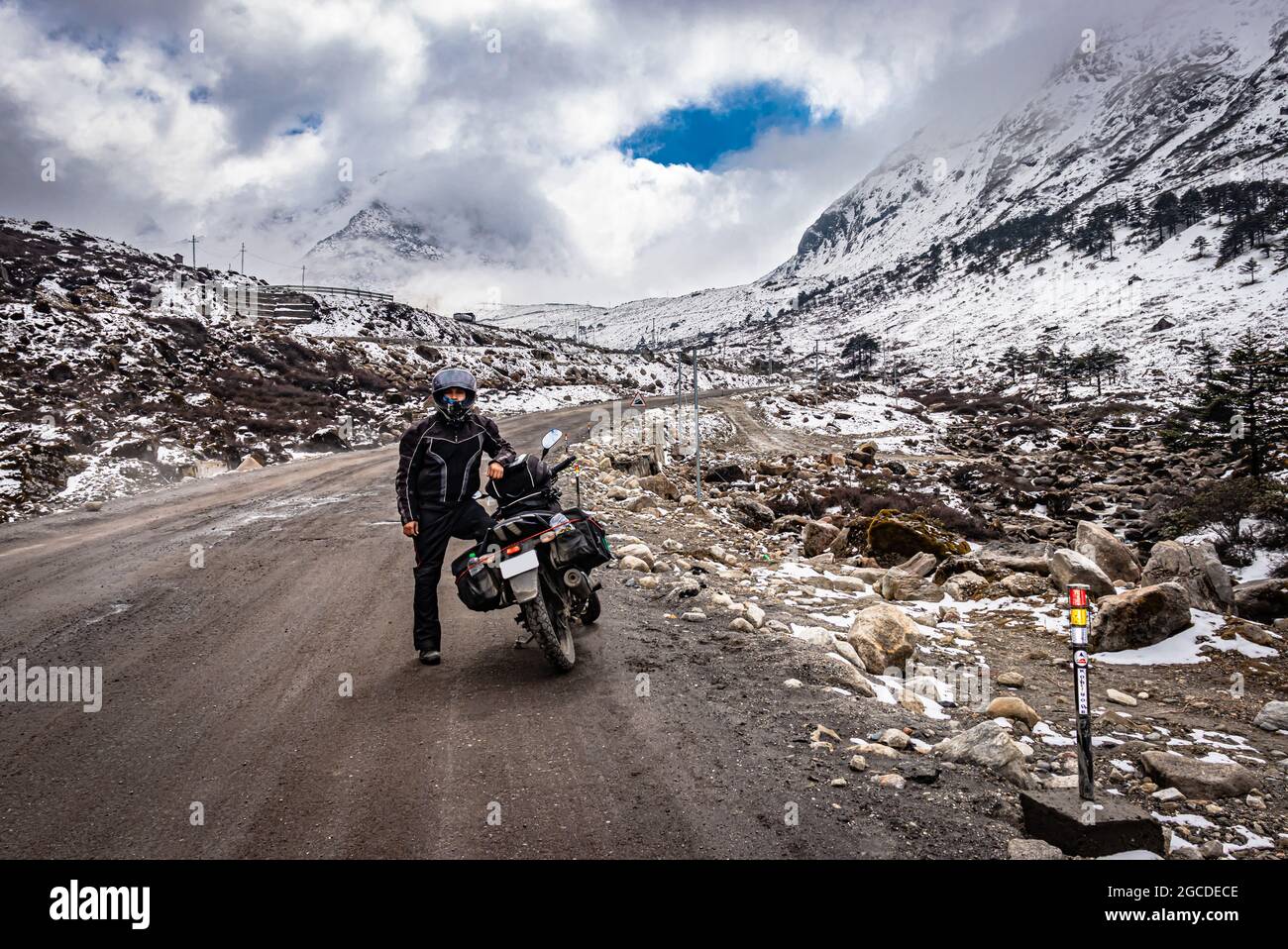 man solo ridder in ridding gears with loaded motorcycle at isolated ...