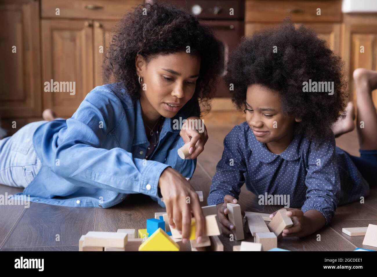 Loving biracial mom play with bricks with small daughter Stock Photo ...