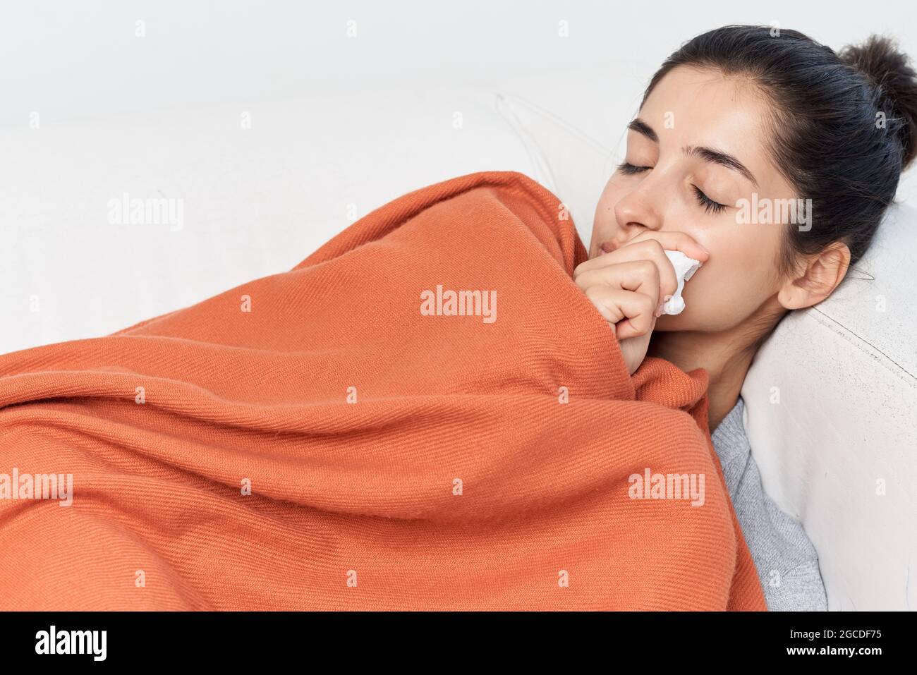 woman lying on bed feeling unwell from health problem Stock Photo - Alamy