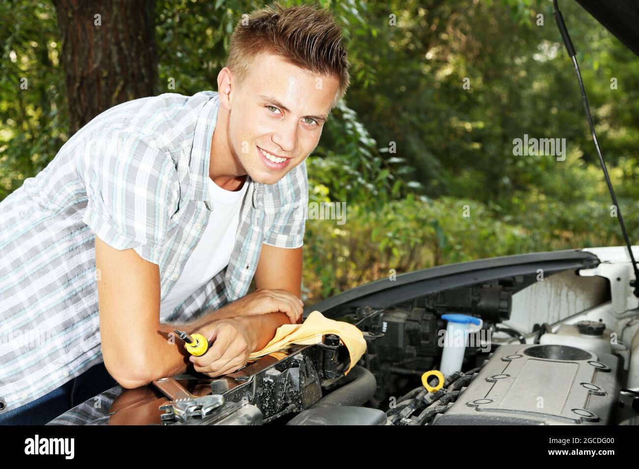 Young driver repairing car engine outdoors Stock Photo - Alamy