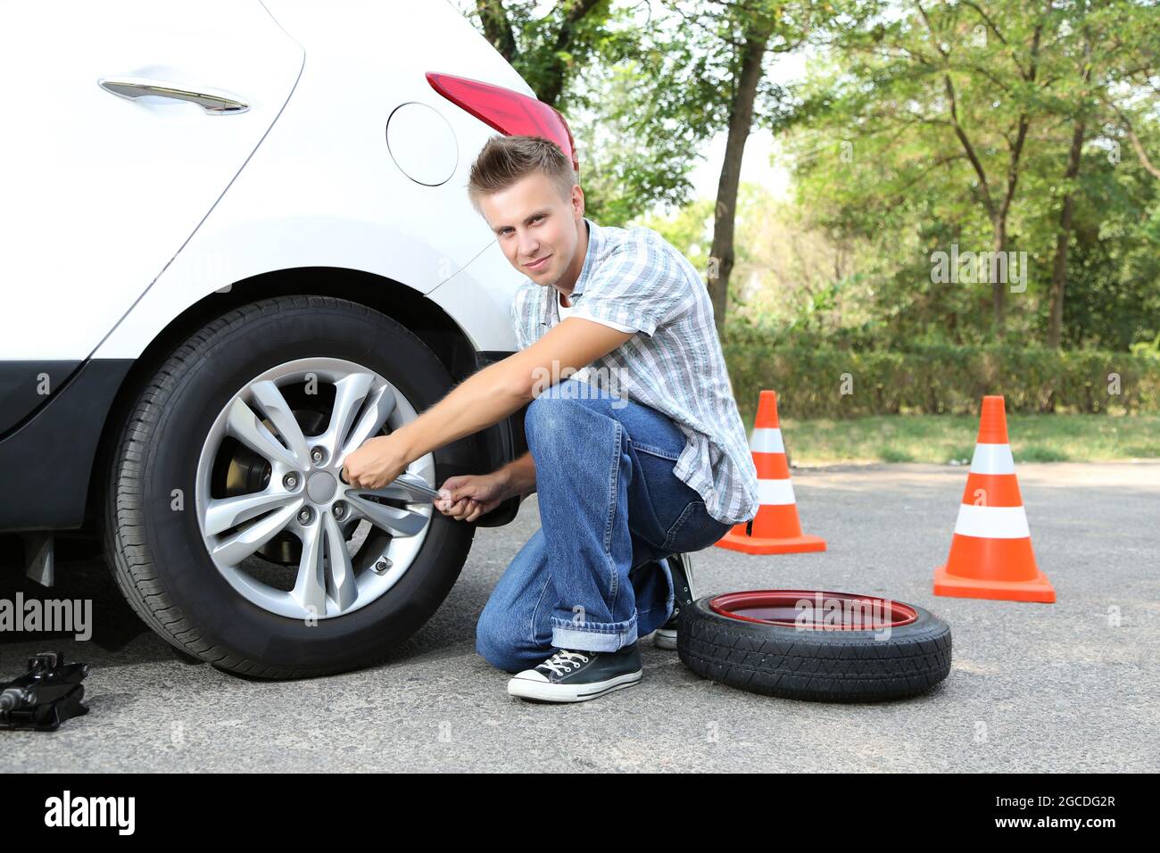 Man driver having trouble at road changing wheel Stock Photo - Alamy Man driver having trouble at road changing wheel Stock Photo - Alamy