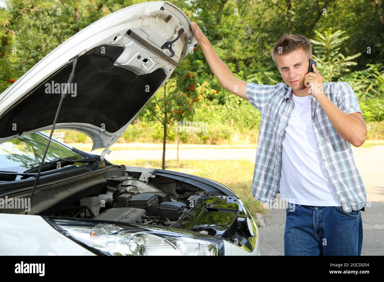 Man calling repair service after car breakdown Stock Photo - Alamy