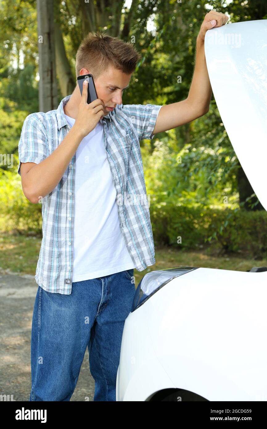Man calling repair service after car breakdown Stock Photo - Alamy