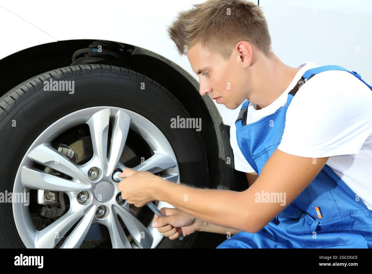 Auto mechanic changing wheel Stock Photo - Alamy