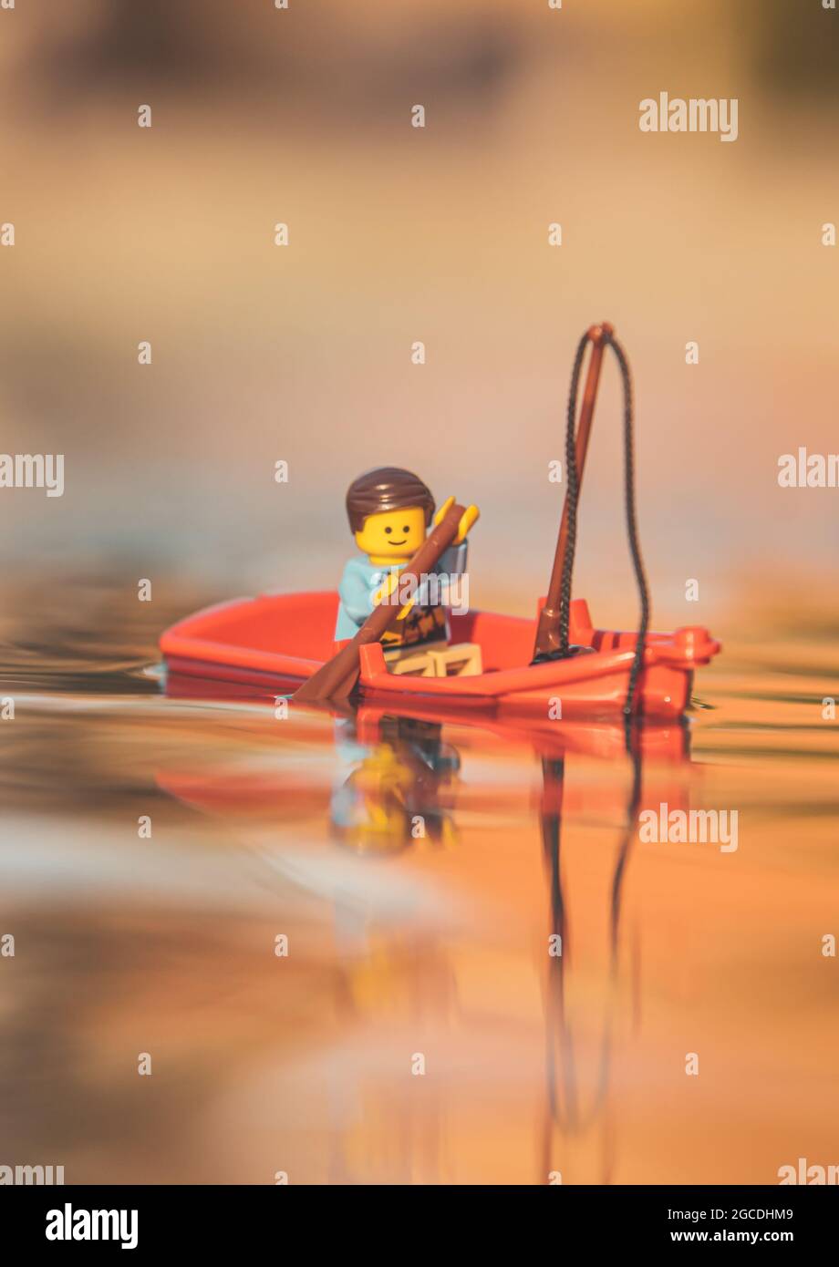 Lego minifigure swimming on red boat Stock Photo - Alamy