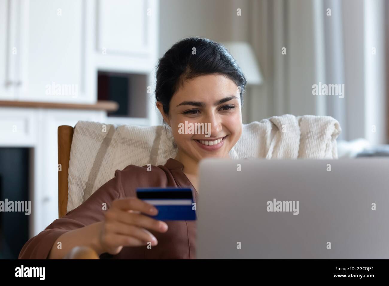 Smiling Indian woman shopping online on computer Stock Photo - Alamy