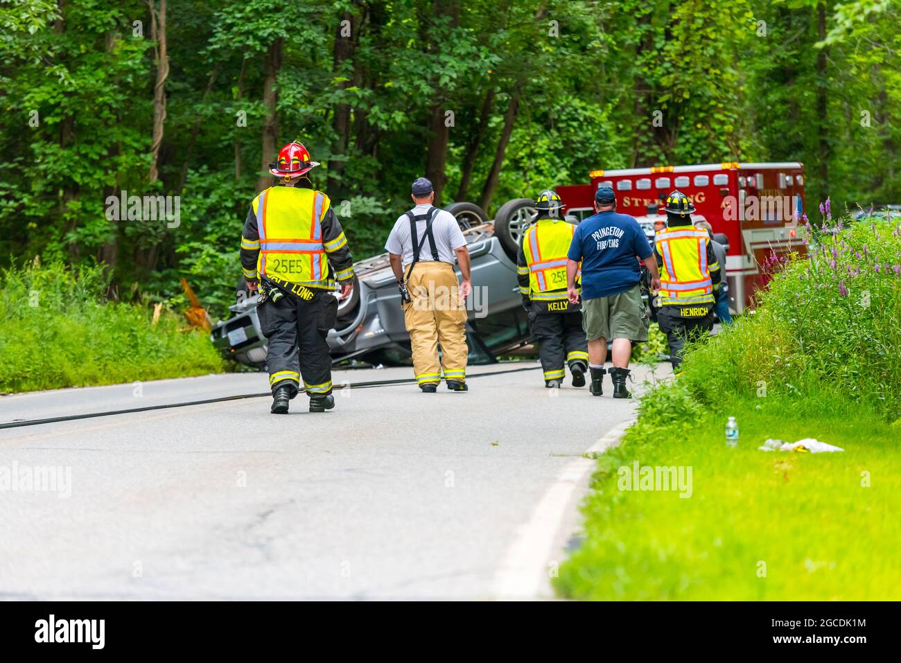 First responders taking care of rollover accident Stock Photo - Alamy