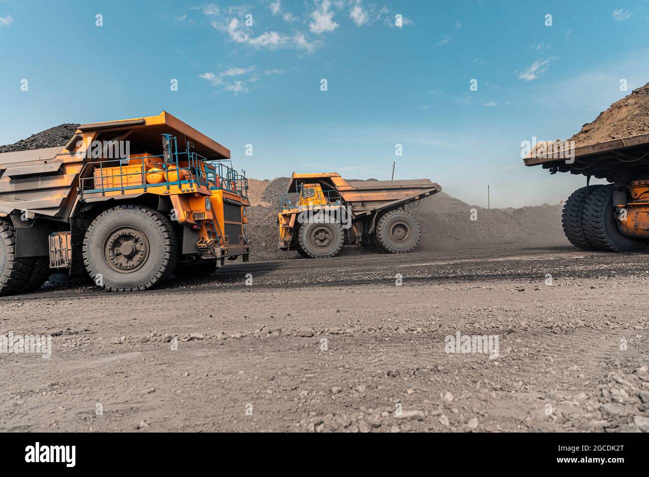 Large quarry dump truck. Big yellow mining truck at work site. Loading ...