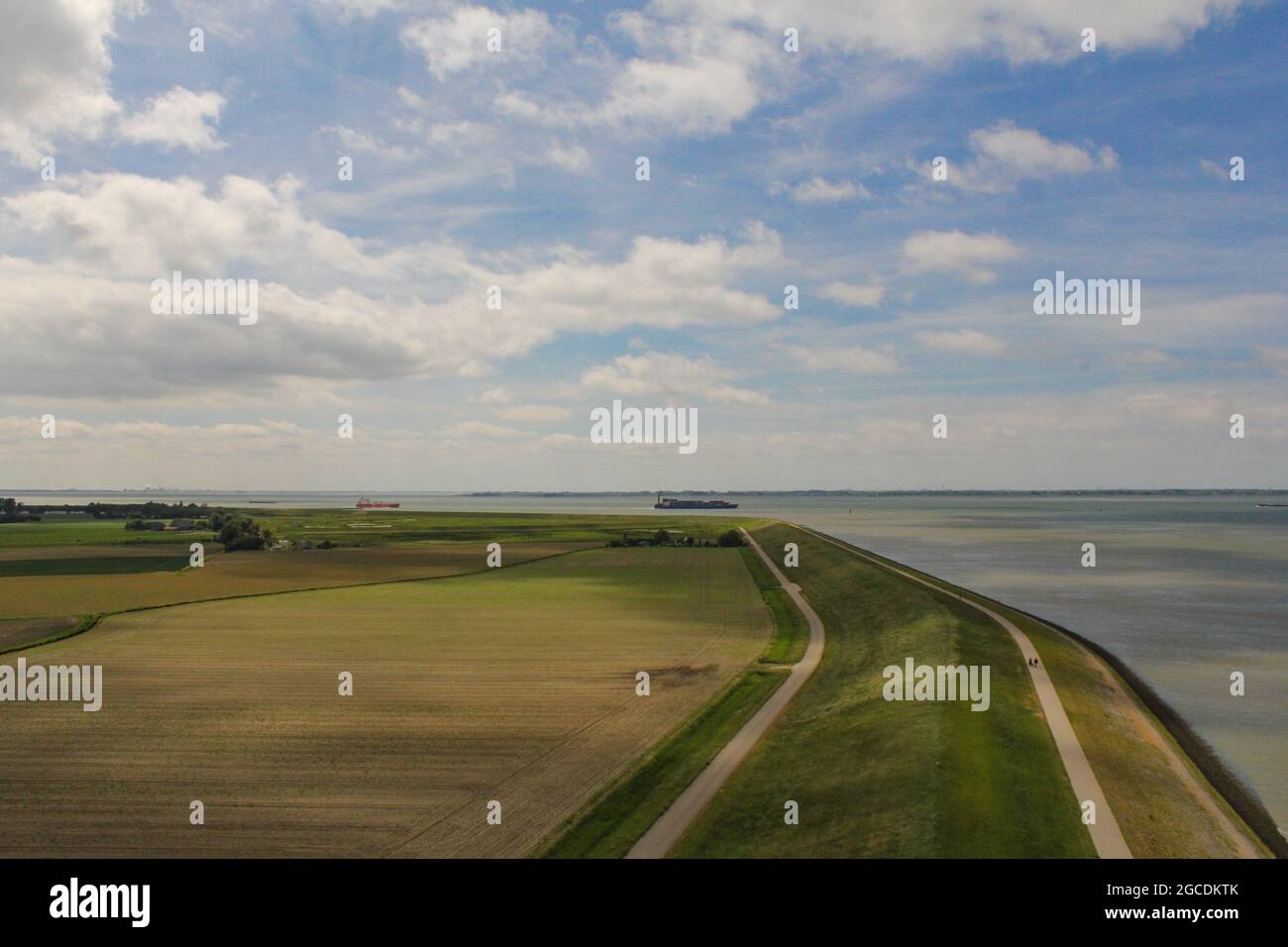 aerial view at the westerschelde sea and the agricultural fields behind ...
