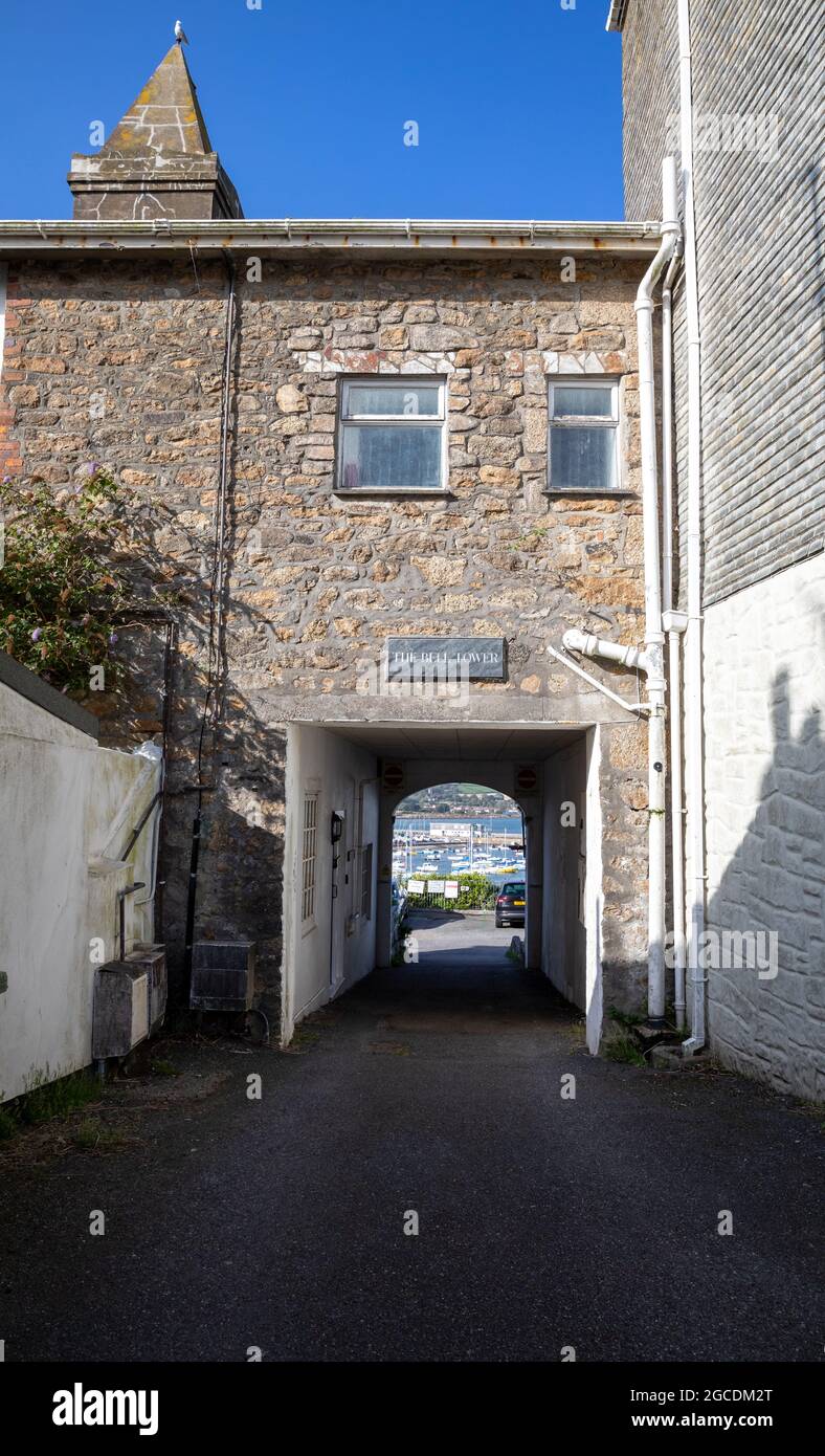 A view of the harbour through a narrow alleyway in Penzance, Cornwall ...