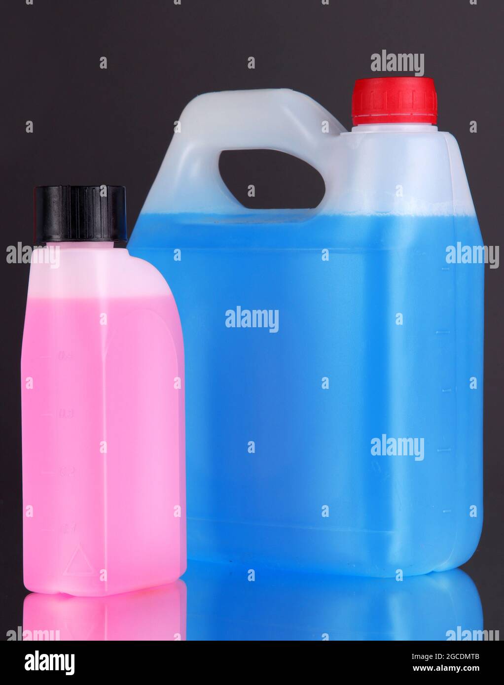 Blue and pink liquids for car in canisters on black background Stock ...