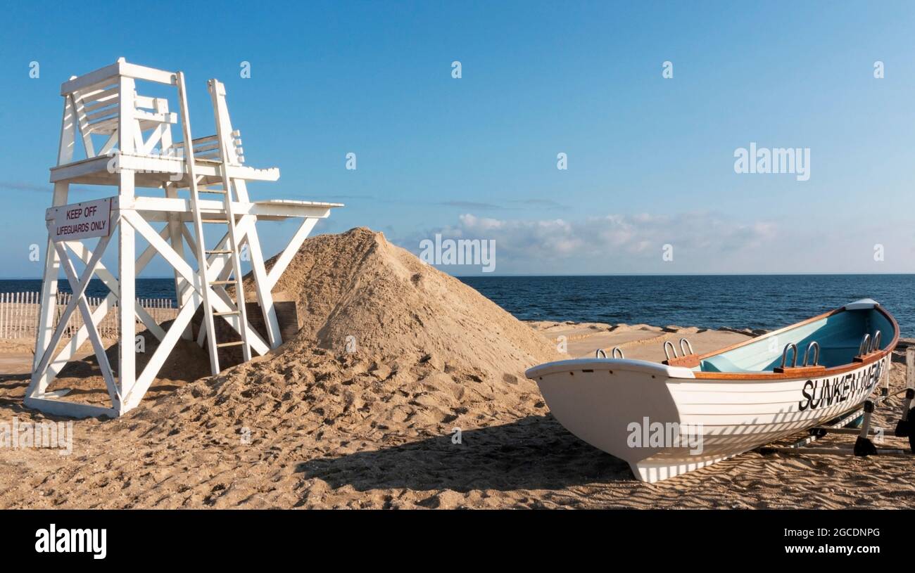 White wooden lifeguard stand and rowboat on the beach looking toward ...