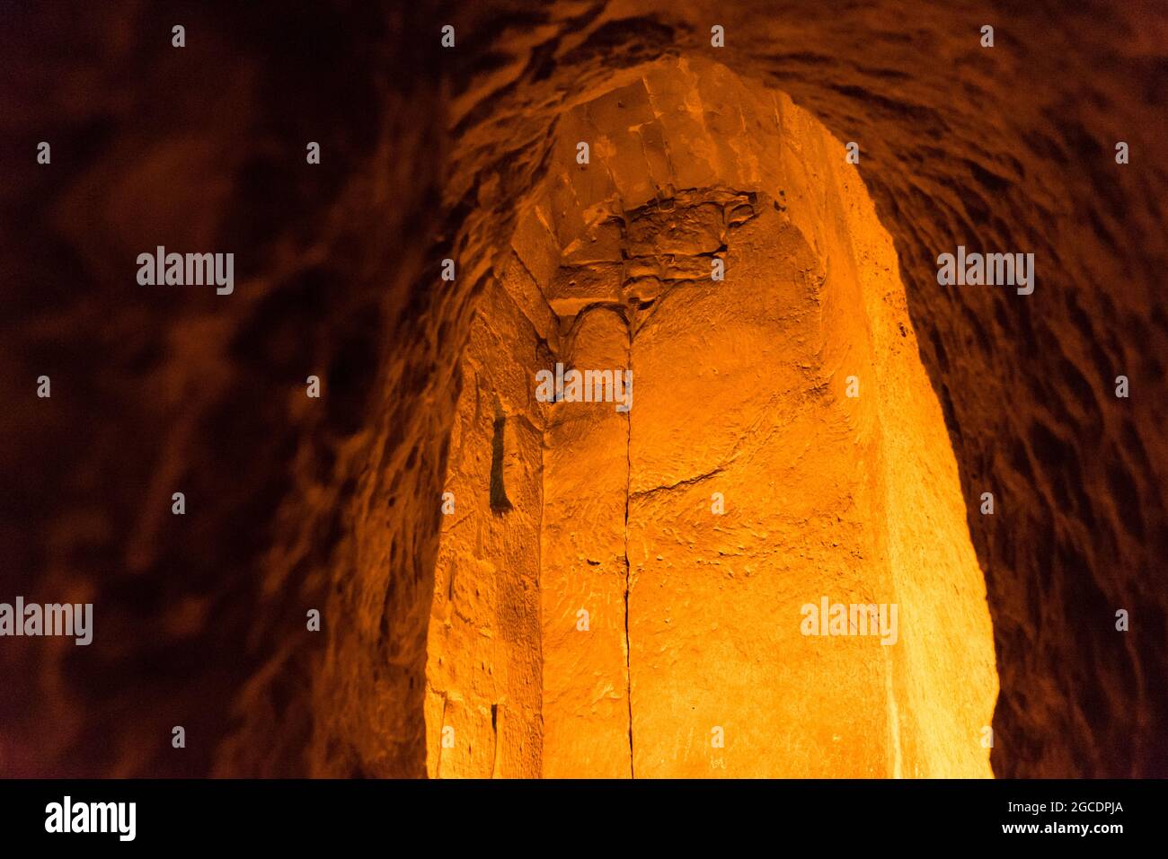 ancient vault of a medieval castle rough stone texture and orange light ...