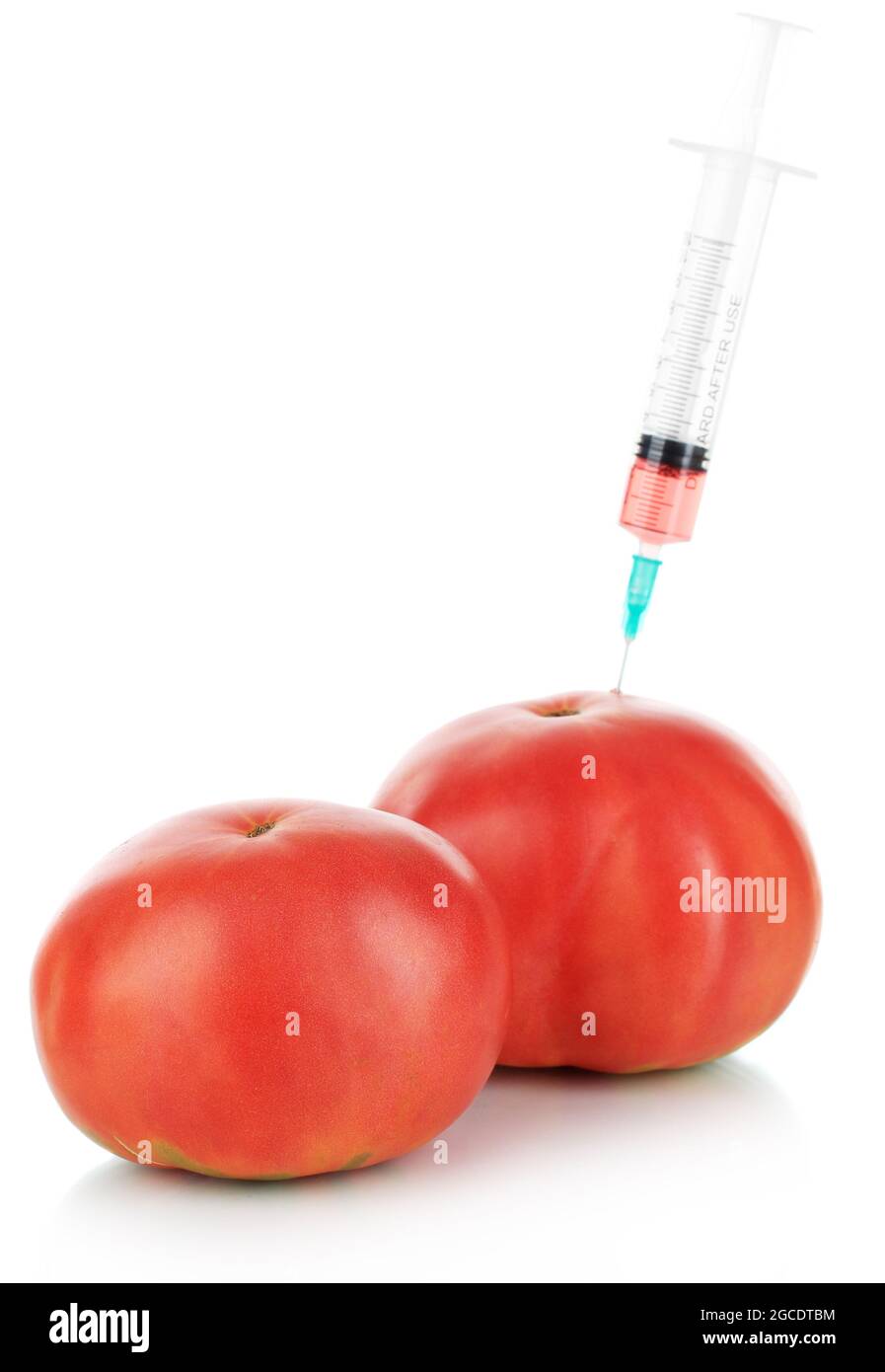 Injection into fresh red tomato isolated on white Stock Photo - Alamy