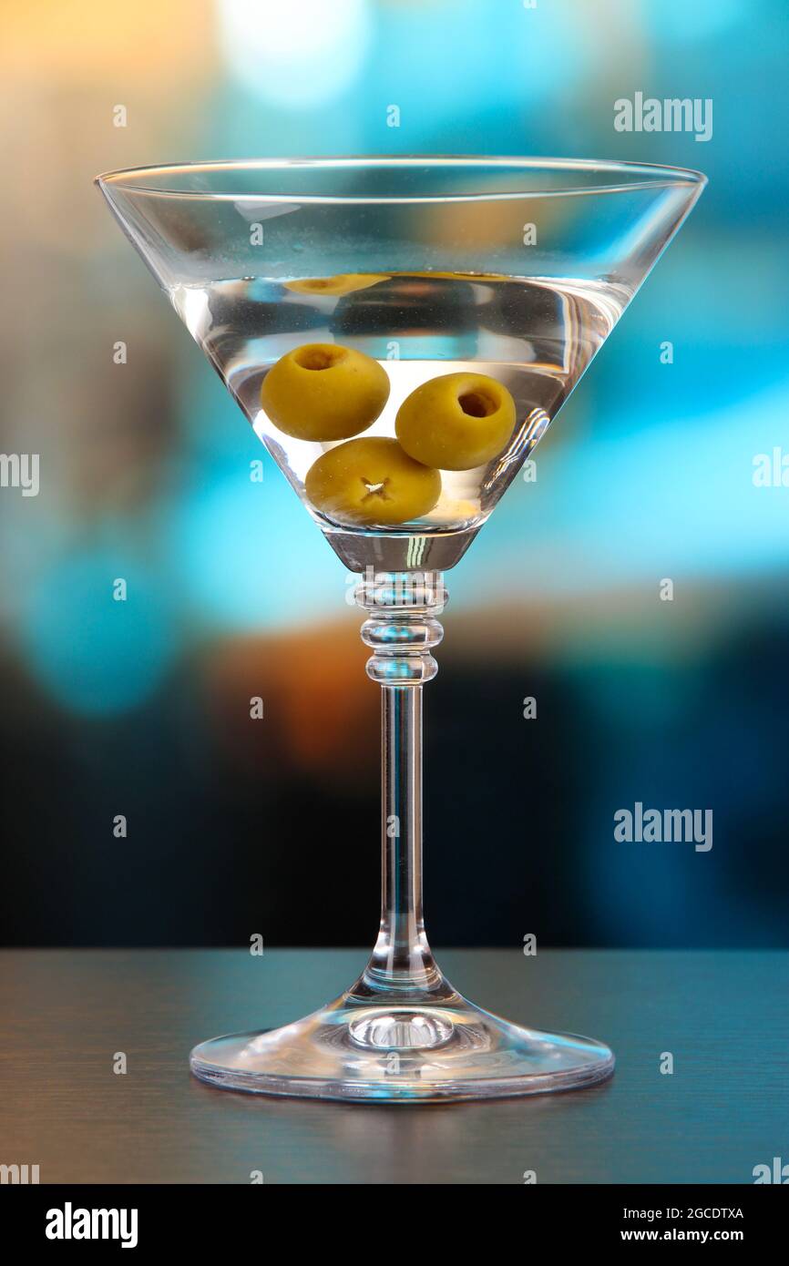 Martini with green olives on table in bar Stock Photo - Alamy