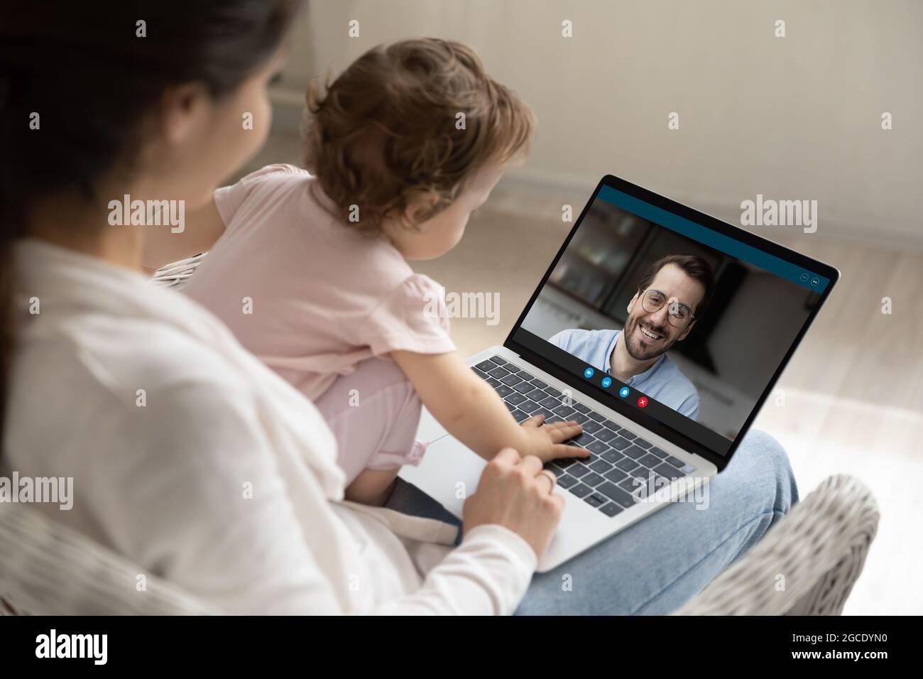 Mother with baby daughter speak on video call with dad Stock Photo - Alamy