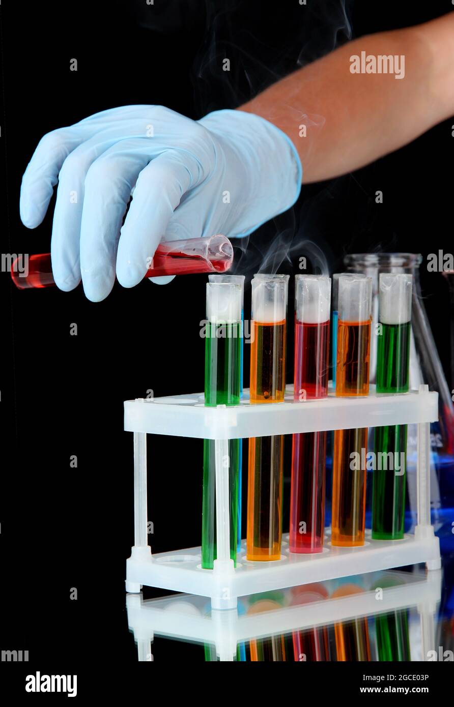 Laboratory test tubes on black background Stock Photo - Alamy
