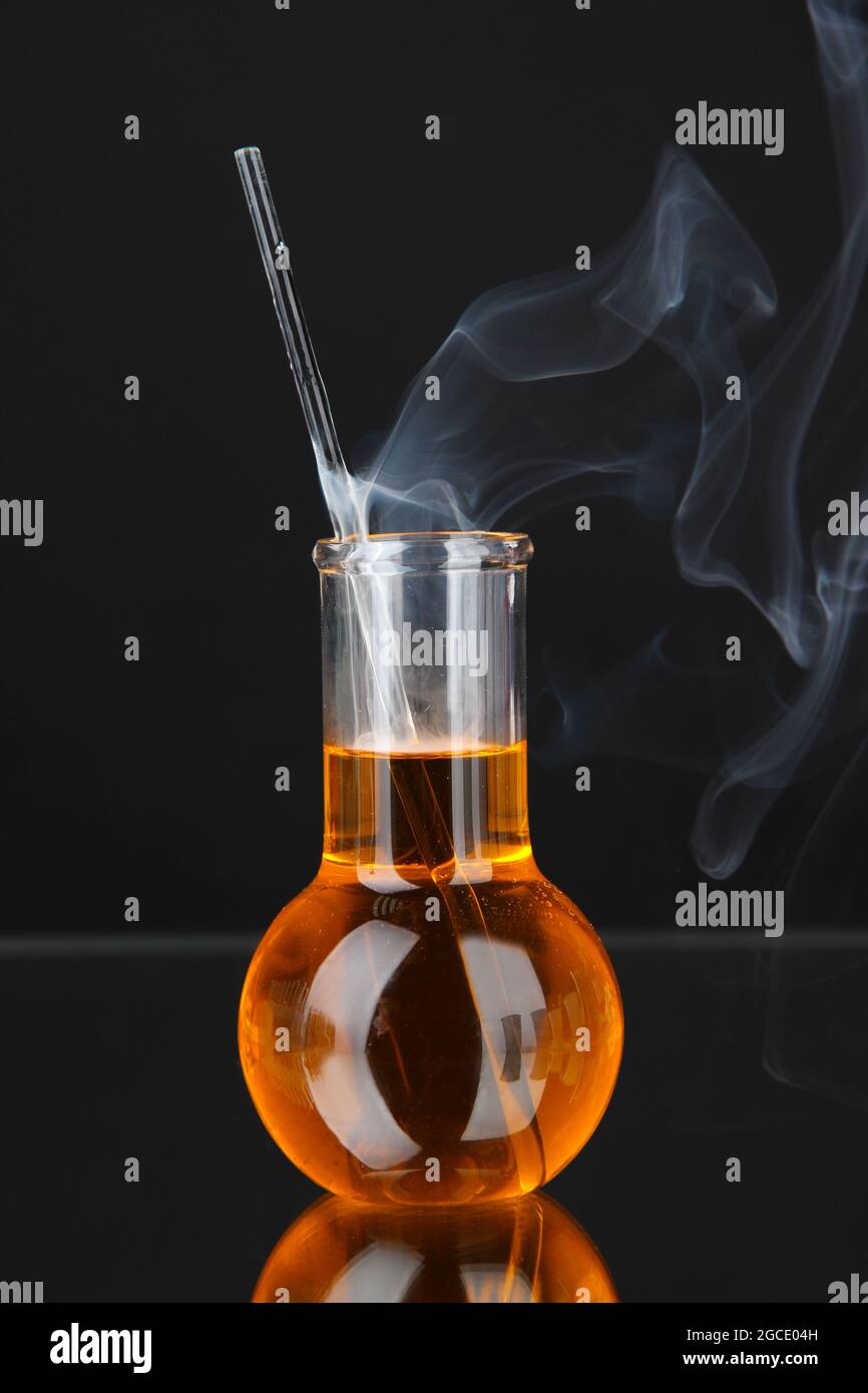 Laboratory beaker on black background Stock Photo - Alamy
