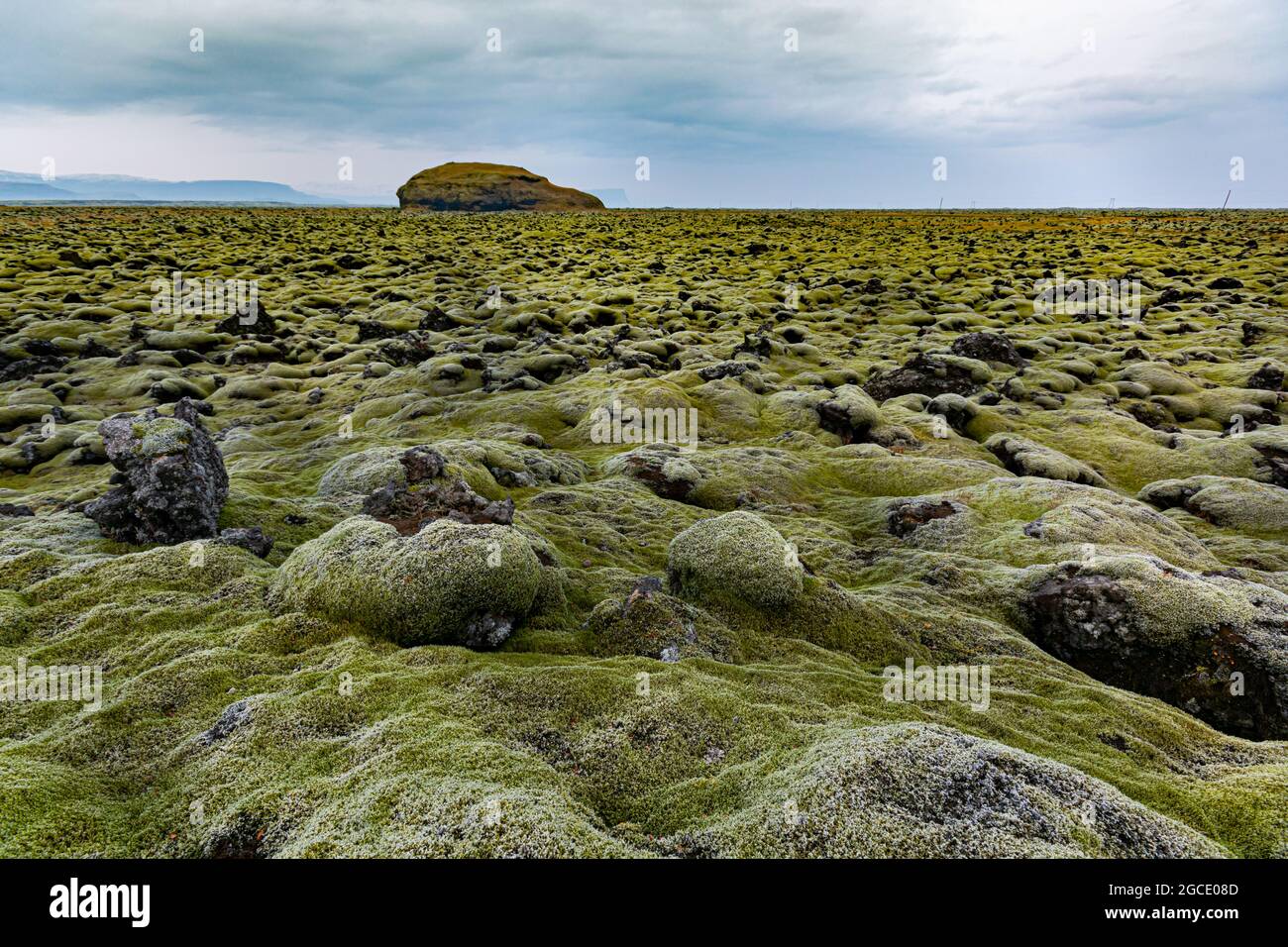 A natural view of moss-covered rocks under a cloudy sky Stock Photo - Alamy