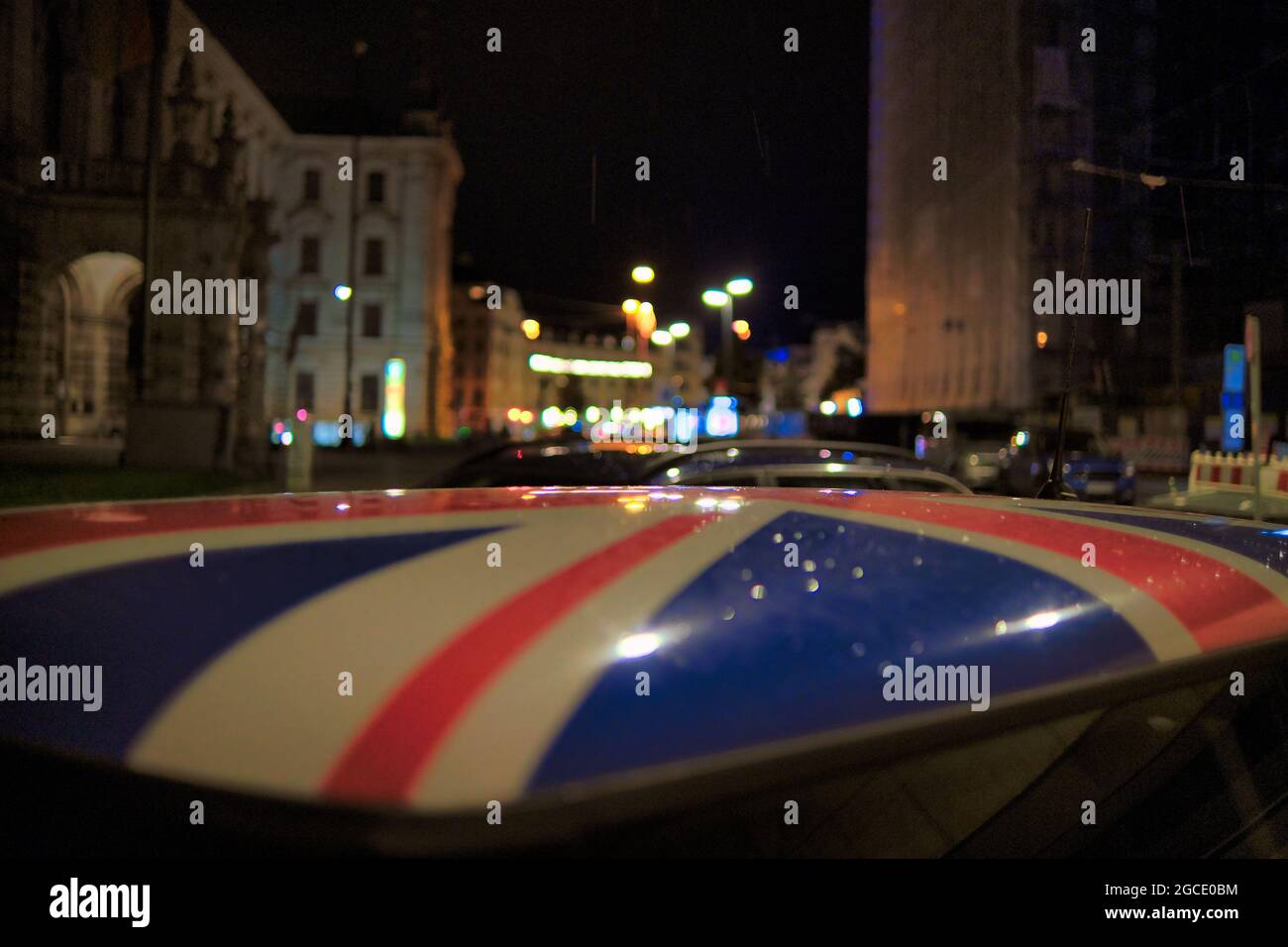 A beautiful night view of the city with the blurred flag of the UK ...