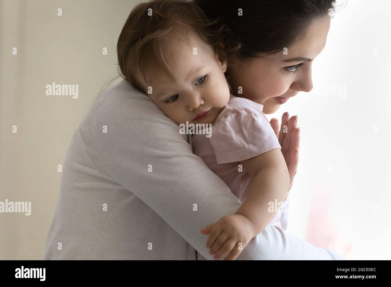 Loving young mom lull cuddle baby daughter Stock Photo - Alamy