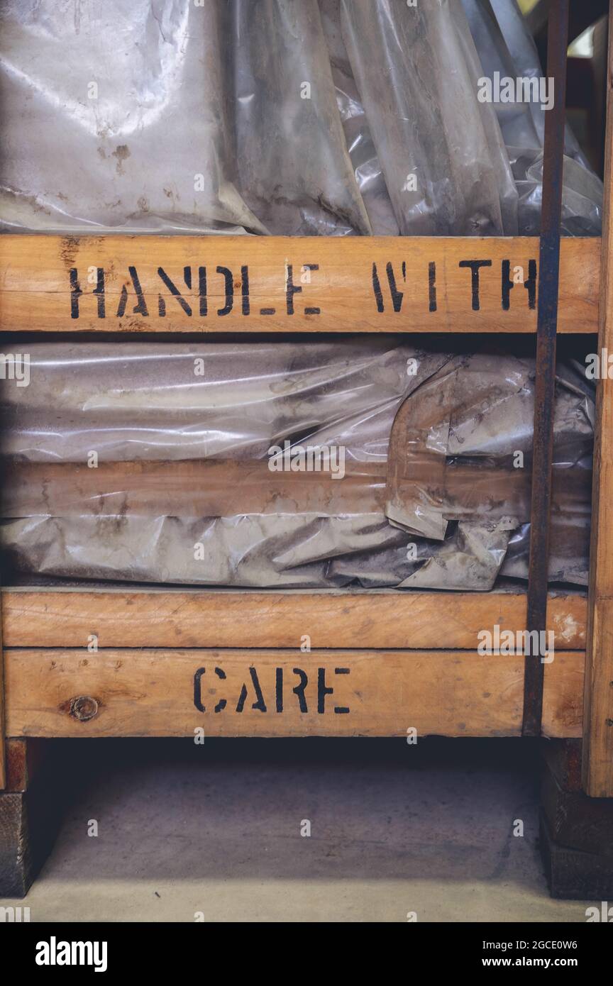 A closeup of a wooden signboard with HANDLE WITH CARE text Stock Photo ...