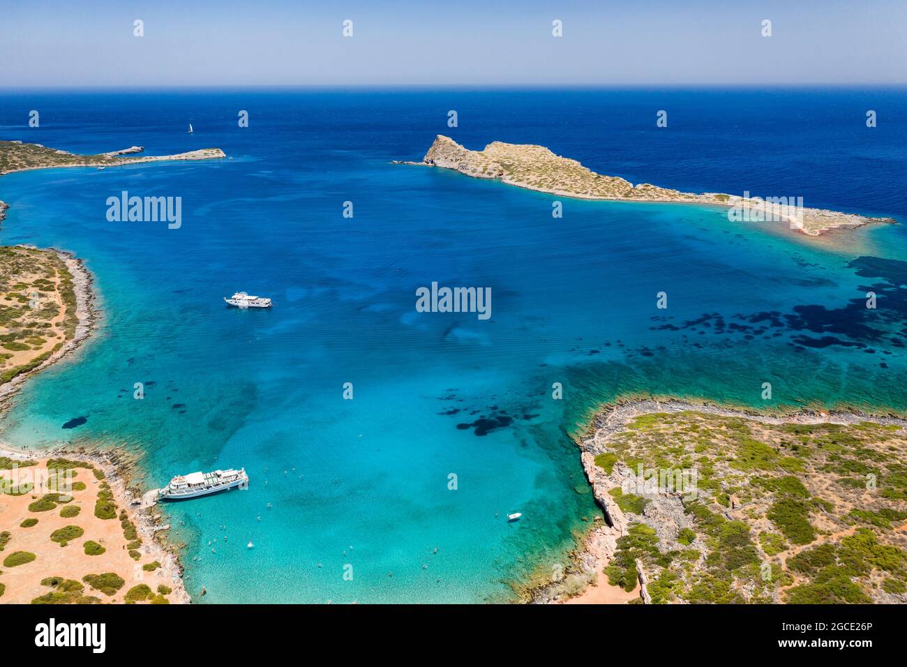 Aerial view of an island surrounded by beautiful, clear blue ocean in ...