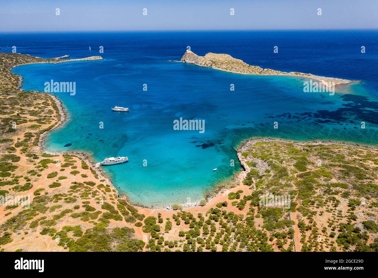 Aerial view of a crystal clear blue ocean and hot, summer landscape ...