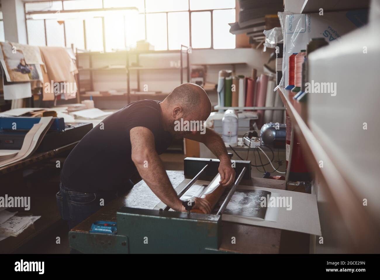 book binder working in a warehouse Stock Photo - Alamy