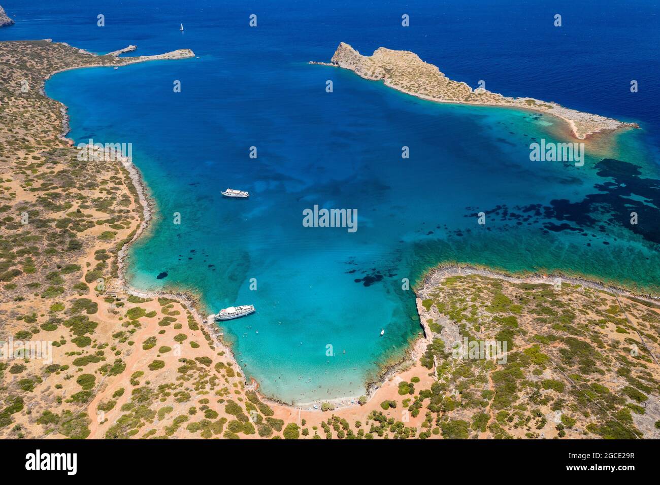 Aerial view of an island surrounded by beautiful, clear blue ocean in ...