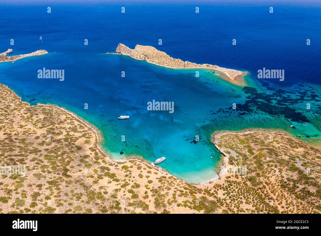Aerial view of an island surrounded by beautiful, clear blue ocean in ...