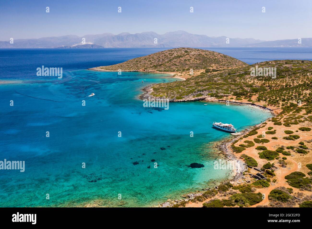 Aerial view of a crystal clear blue ocean and hot, summer landscape ...