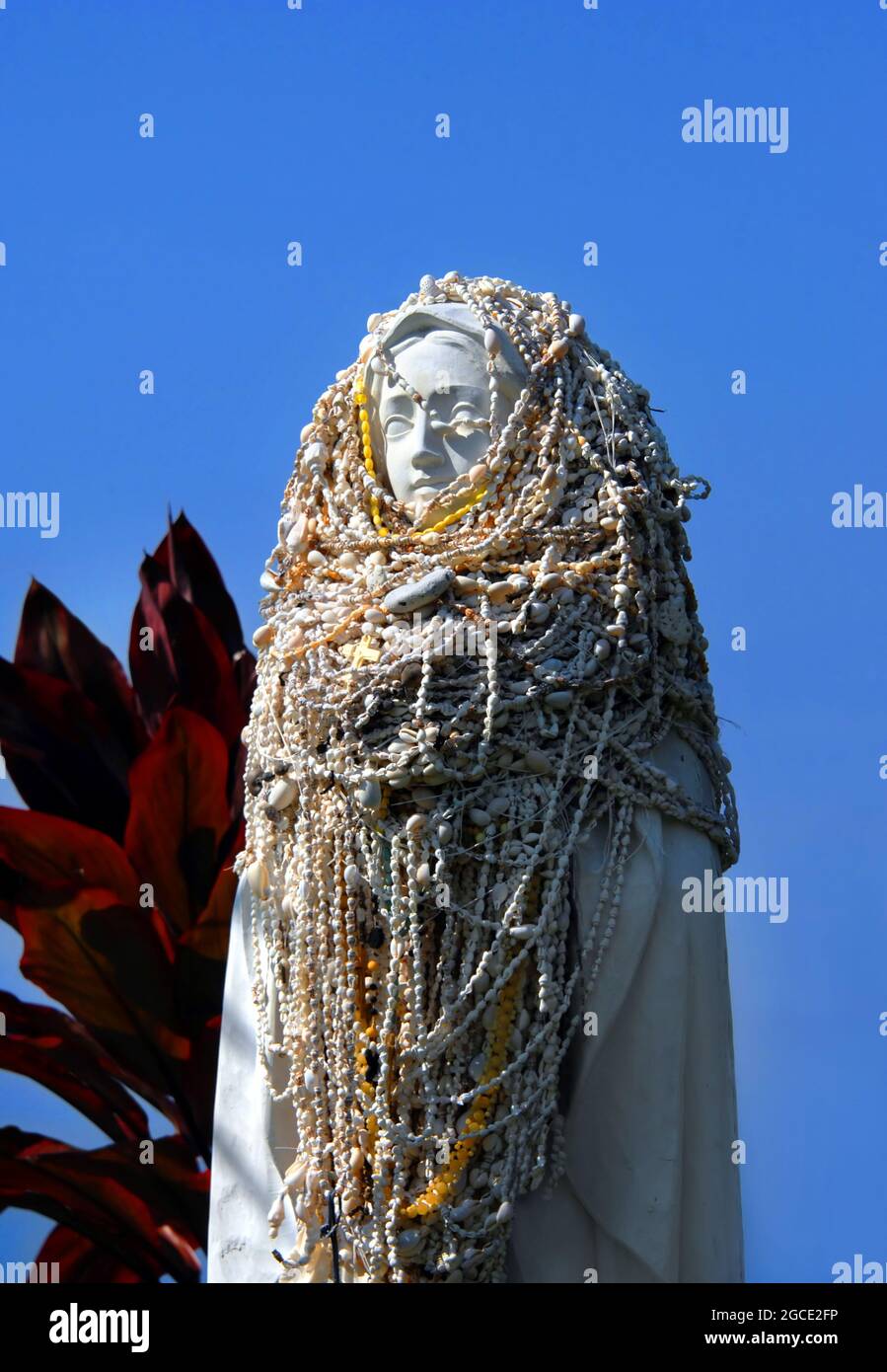 Statue of Virgin Mary is covered in shell necklaces at St. Benedicts ...
