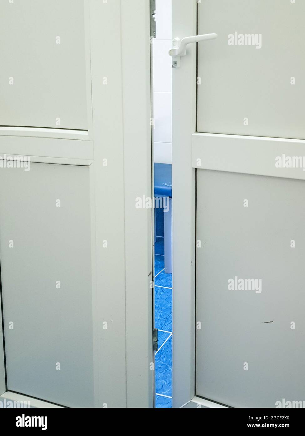 A slightly open door to a medical laboratory or a doctor's office, a ...