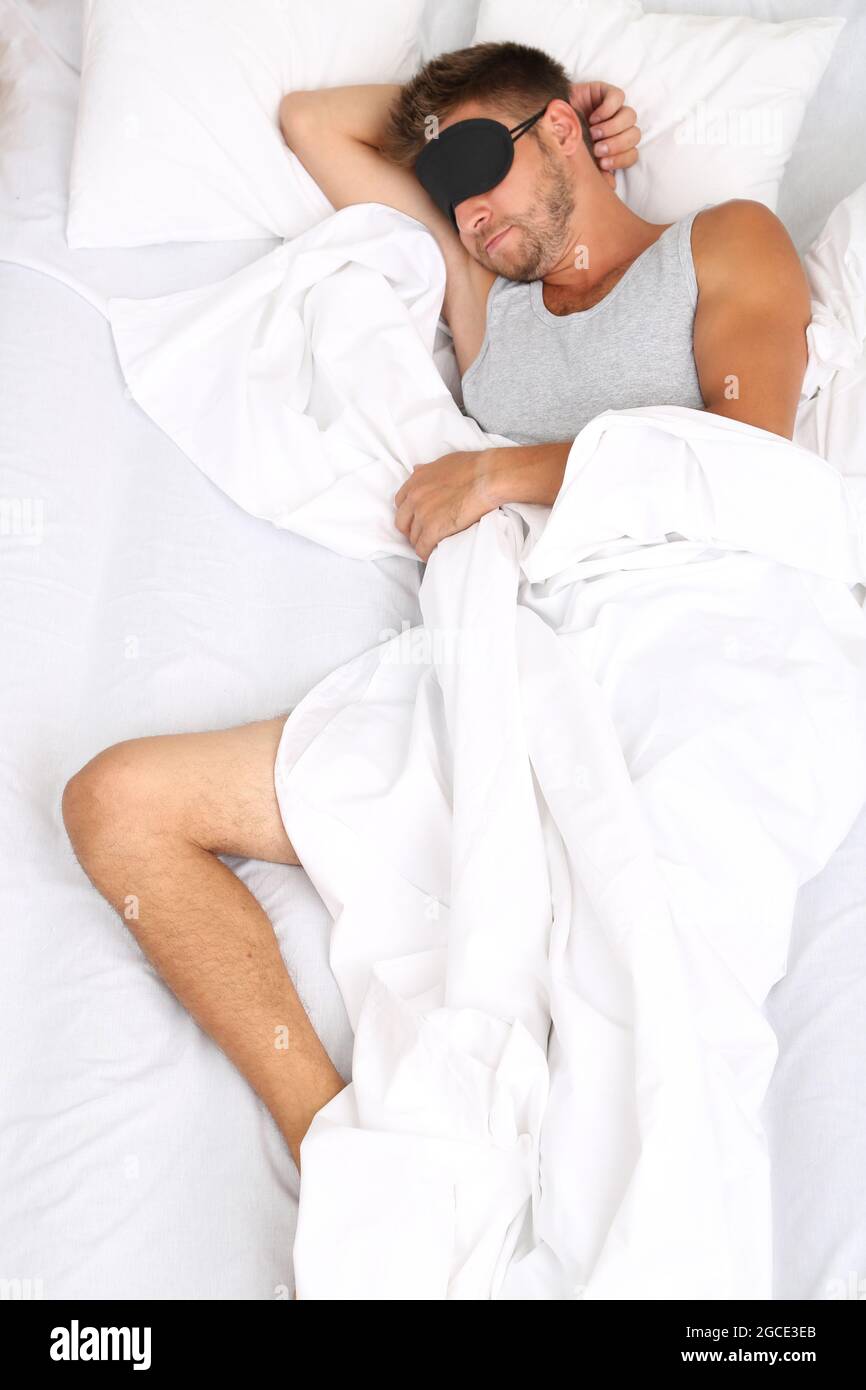 Handsome young man in bed Stock Photo - Alamy