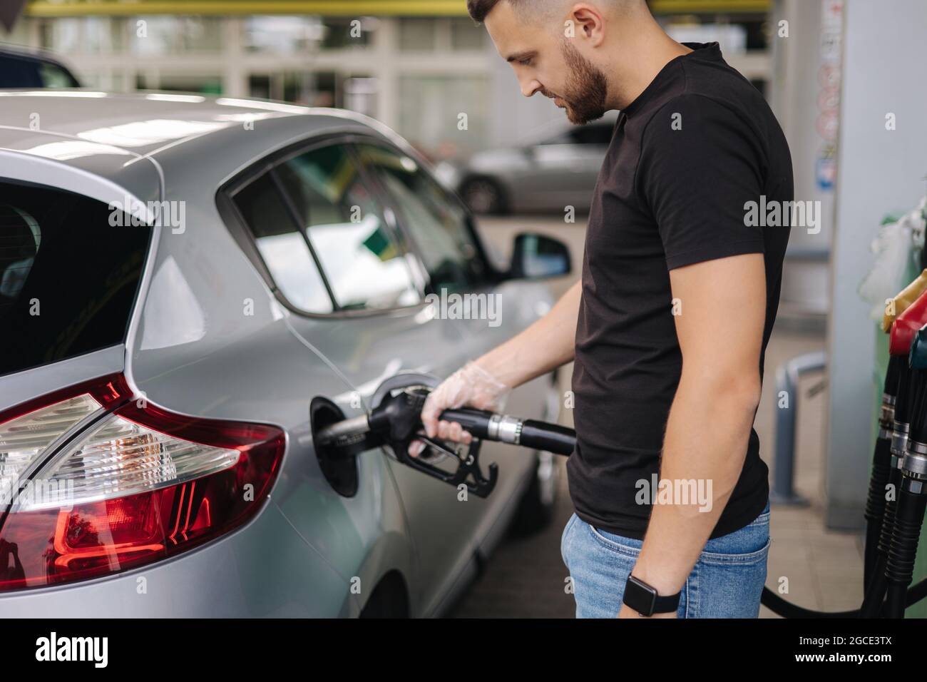 Man is refueling at gas station. Male hand filling benzine gasoline ...