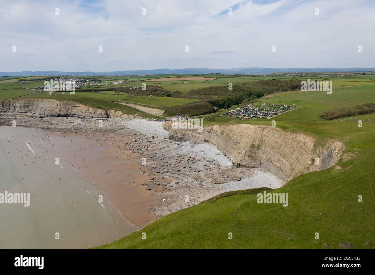 Aerial view of sea cliffs, rock formations and a sandy beach ...