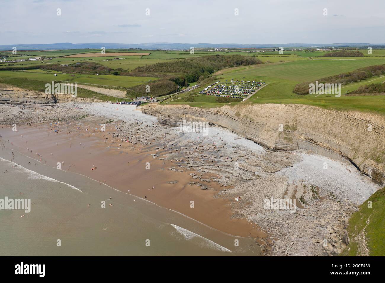 Aerial view of sea cliffs, rock formations and a sandy beach ...